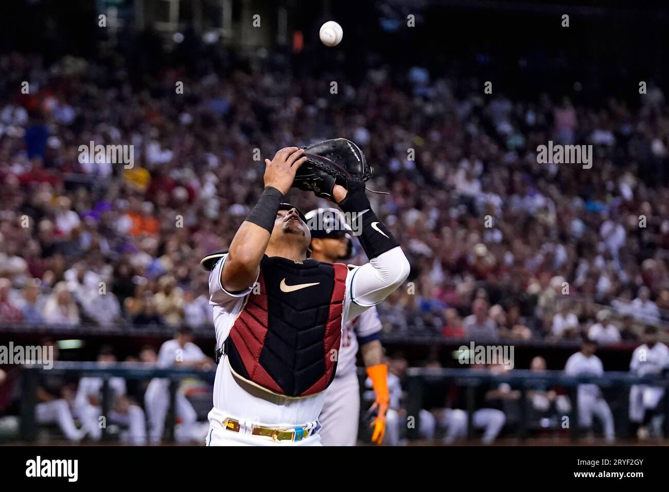 Arizona Diamondbacks catcher Gabriel Moreno, front, makes a catch on a ...
