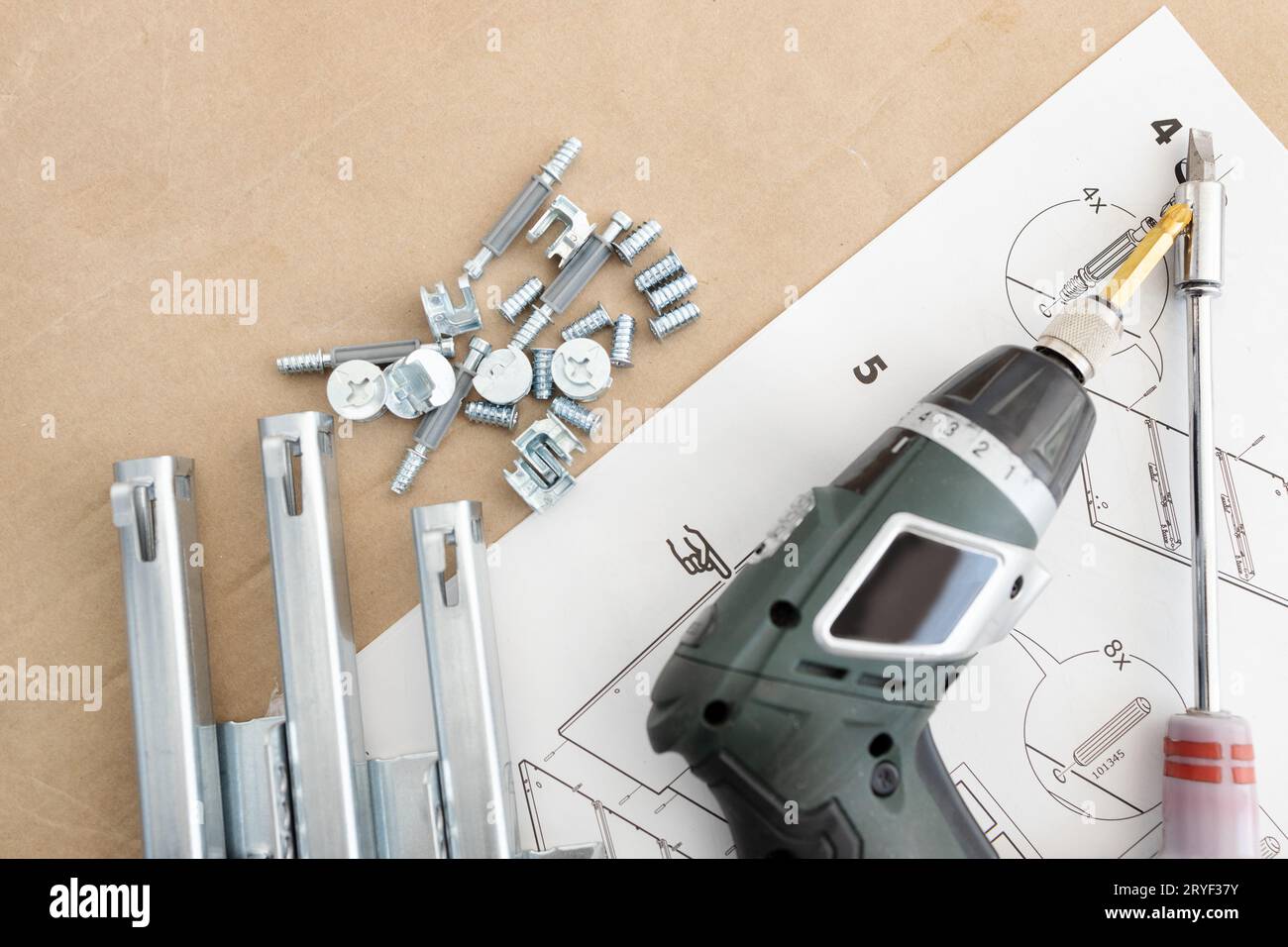 Top view of a cordless screwdriver, drawer sliders, screws and ...