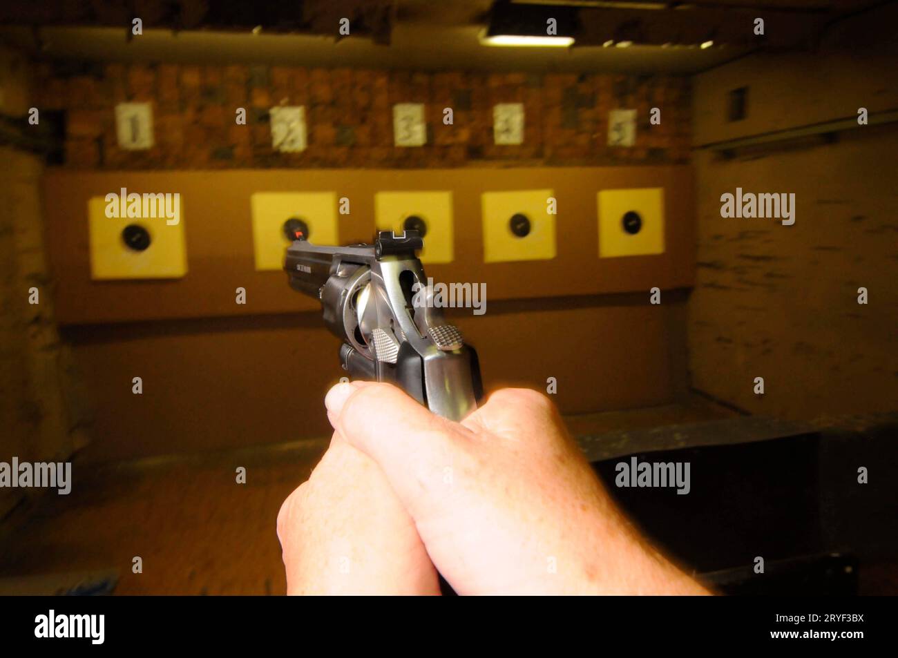 Sport shooter firing at target Stock Photo - Alamy