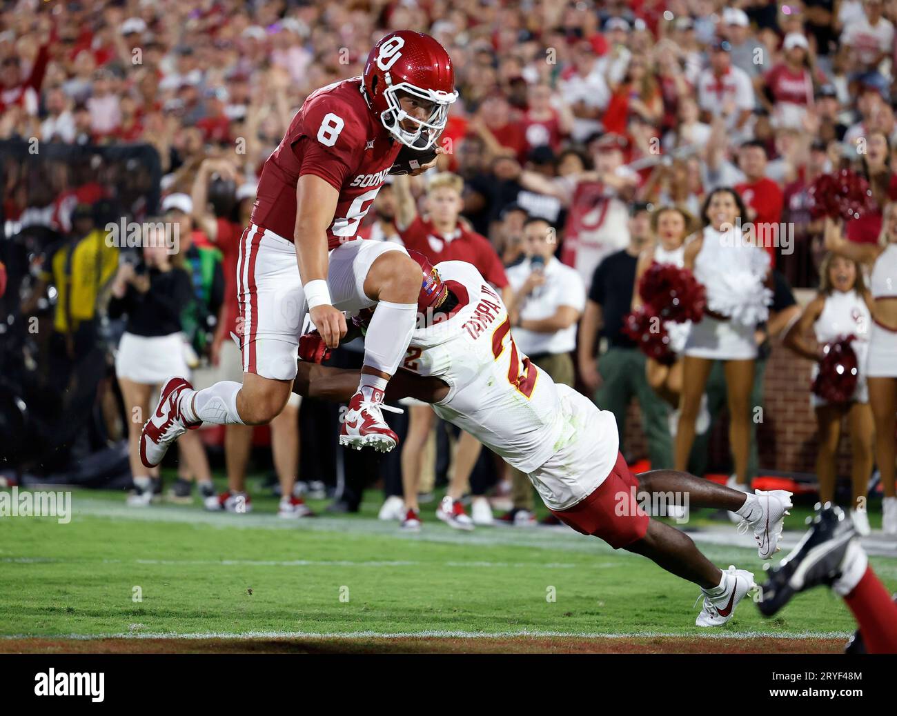 Oklahoma quarterback Dillon Gabriel (8) leaps past Iowa State defensive ...