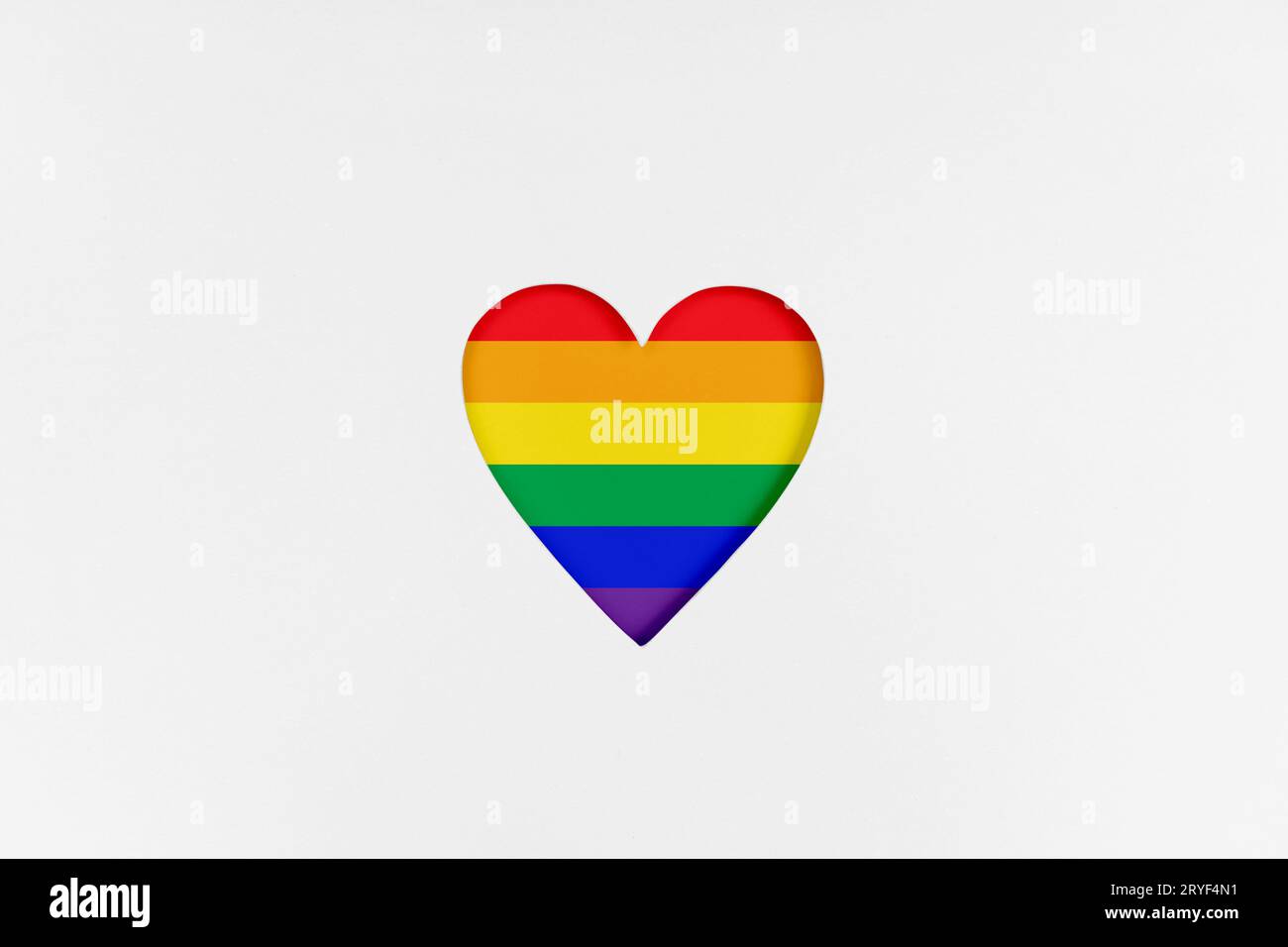 Heart shape with New redesigned LGBTQ pride flag on white cardboard ...