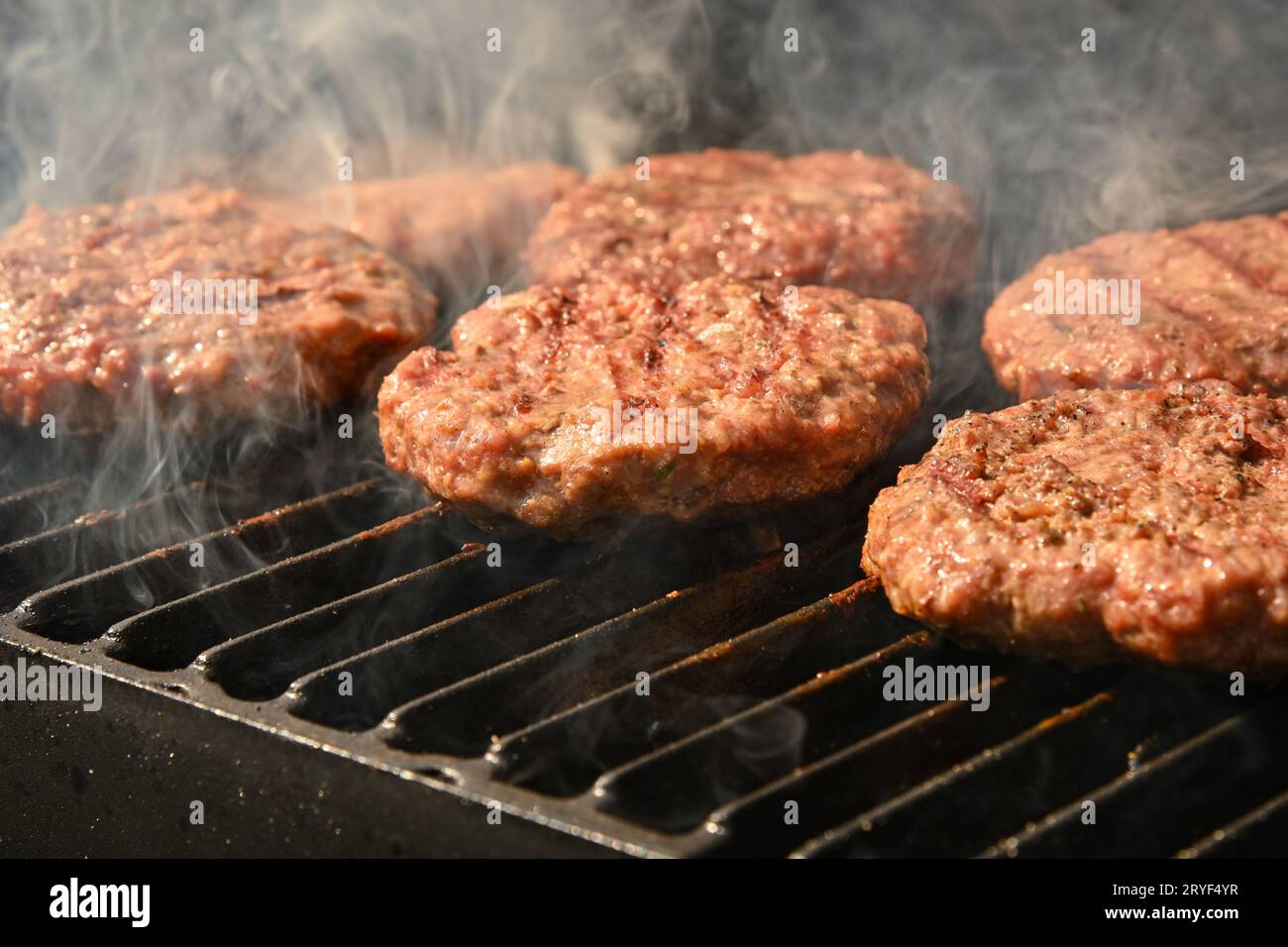 Beef burger for hamburger on barbecue grill Stock Photo - Alamy