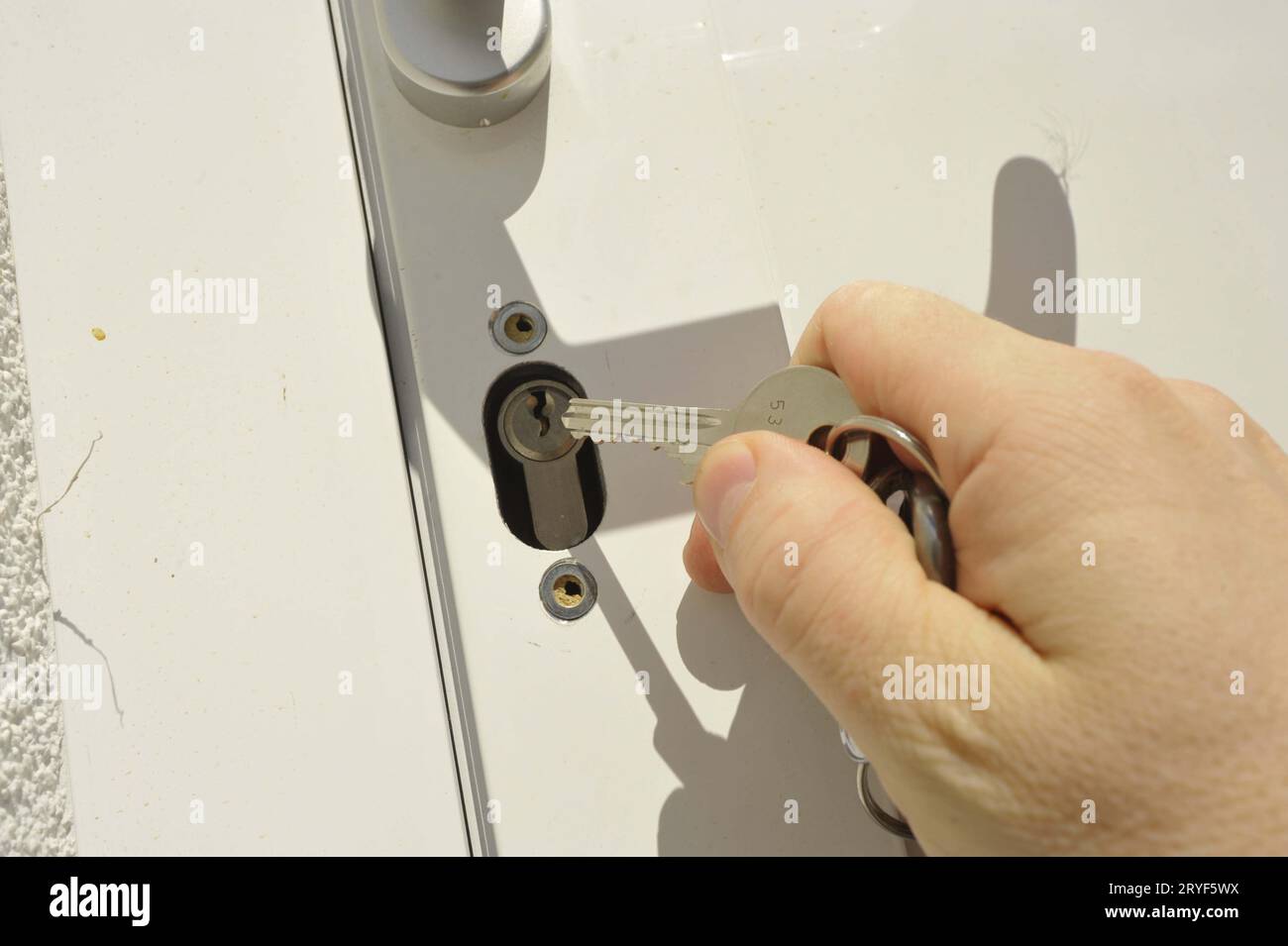 Lock the door with a key Stock Photo - Alamy