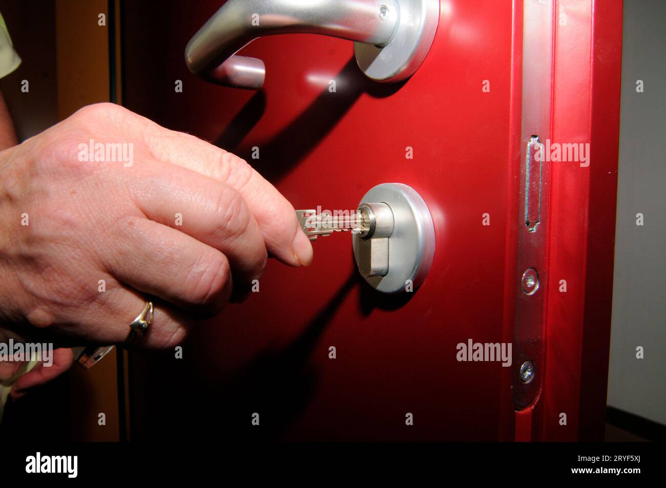 Lock the door with a key Stock Photo - Alamy