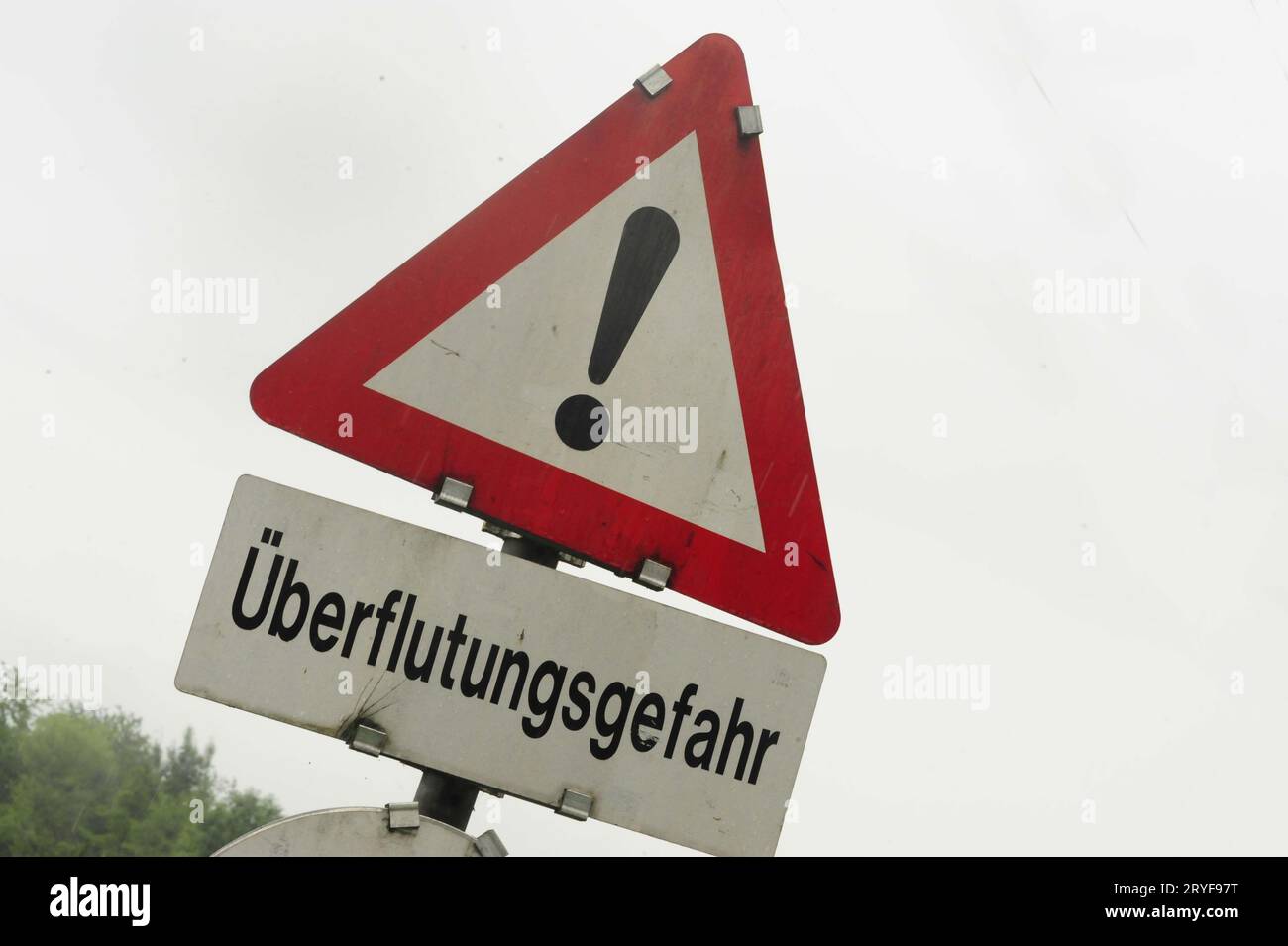 Warning sign flood and danger of flooding Stock Photo - Alamy