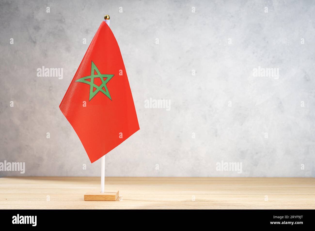 Morocco table flag on white textured wall. Copy space for text, designs ...