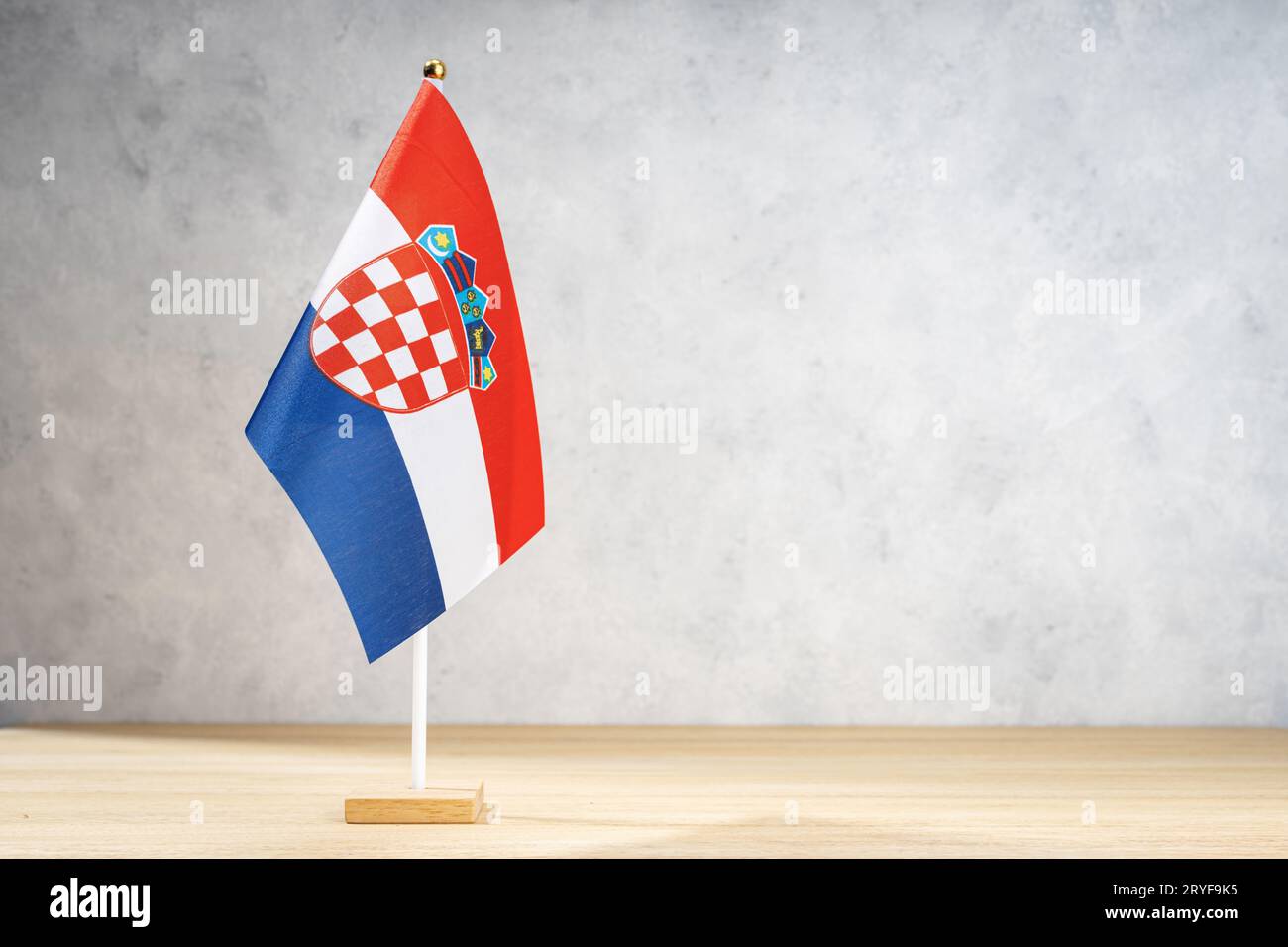Croatia table flag on white textured wall. Copy space for text, designs ...