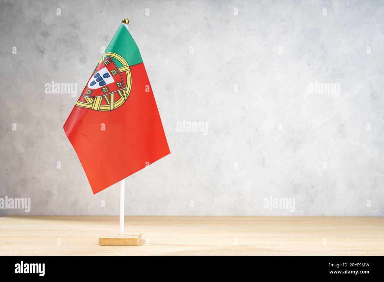 Portugal table flag on white textured wall. Copy space for text ...