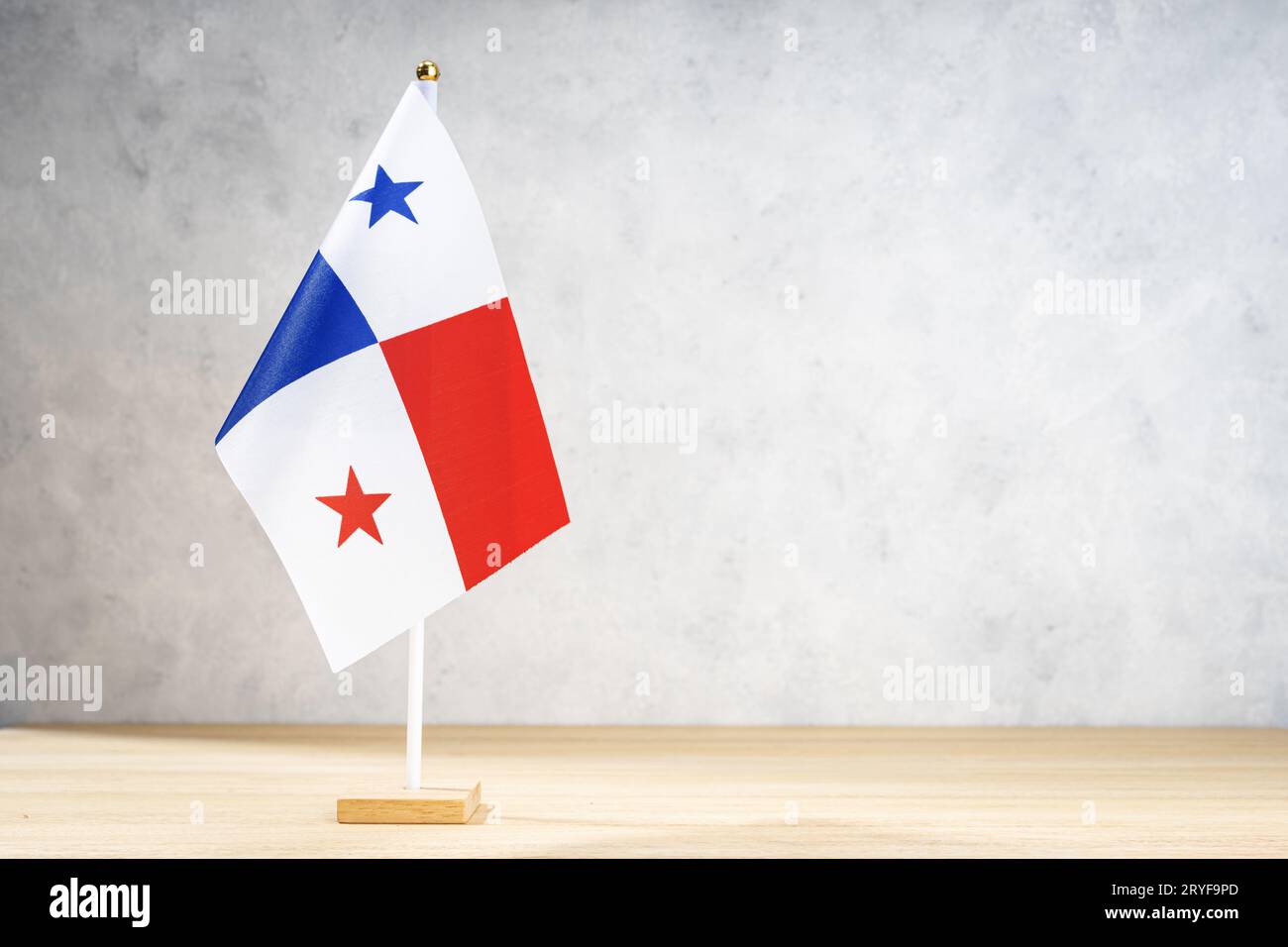 Panama table flag on white textured wall. Copy space for text, designs ...