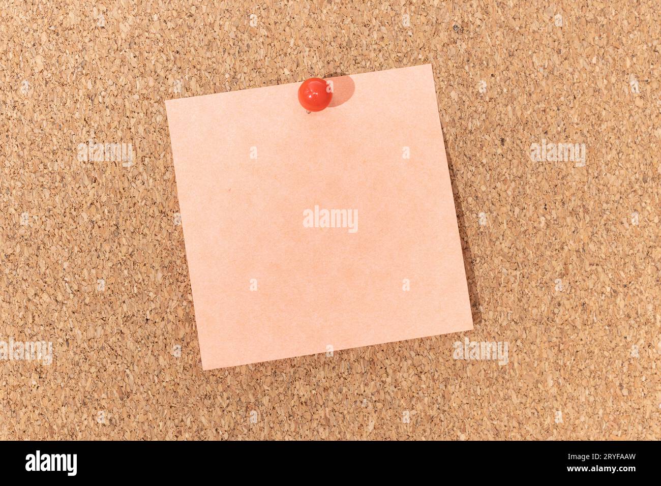 Blank note and push pin on cork board. Template to ad text or drawings ...