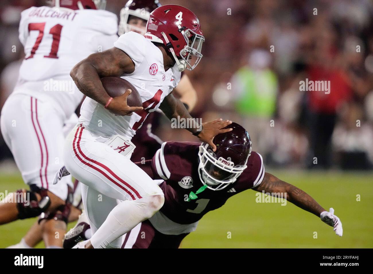 Alabama quarterback Jalen Milroe (4) stiff arms Mississippi State ...