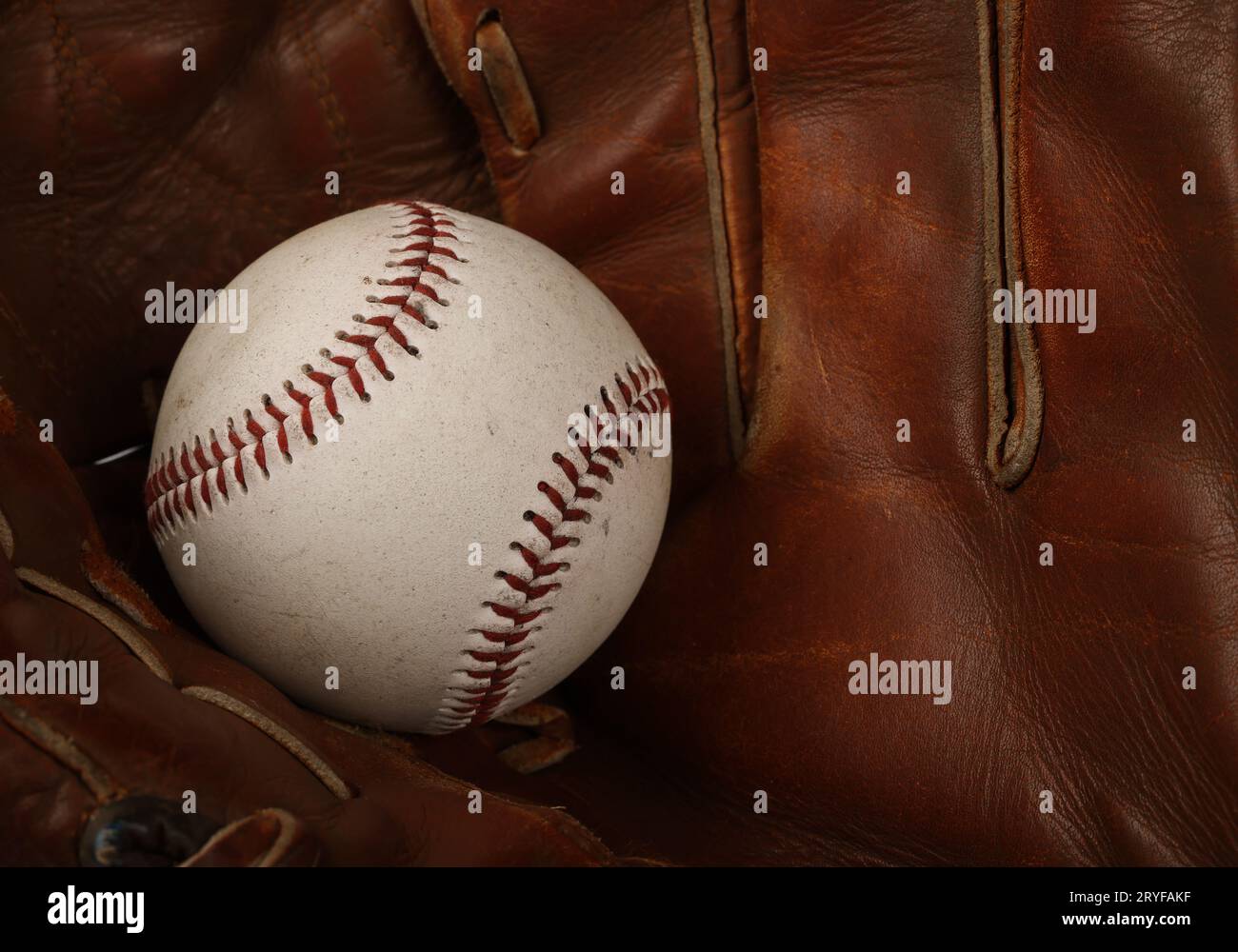 Baseball ball in vintage leather glove Stock Photo - Alamy