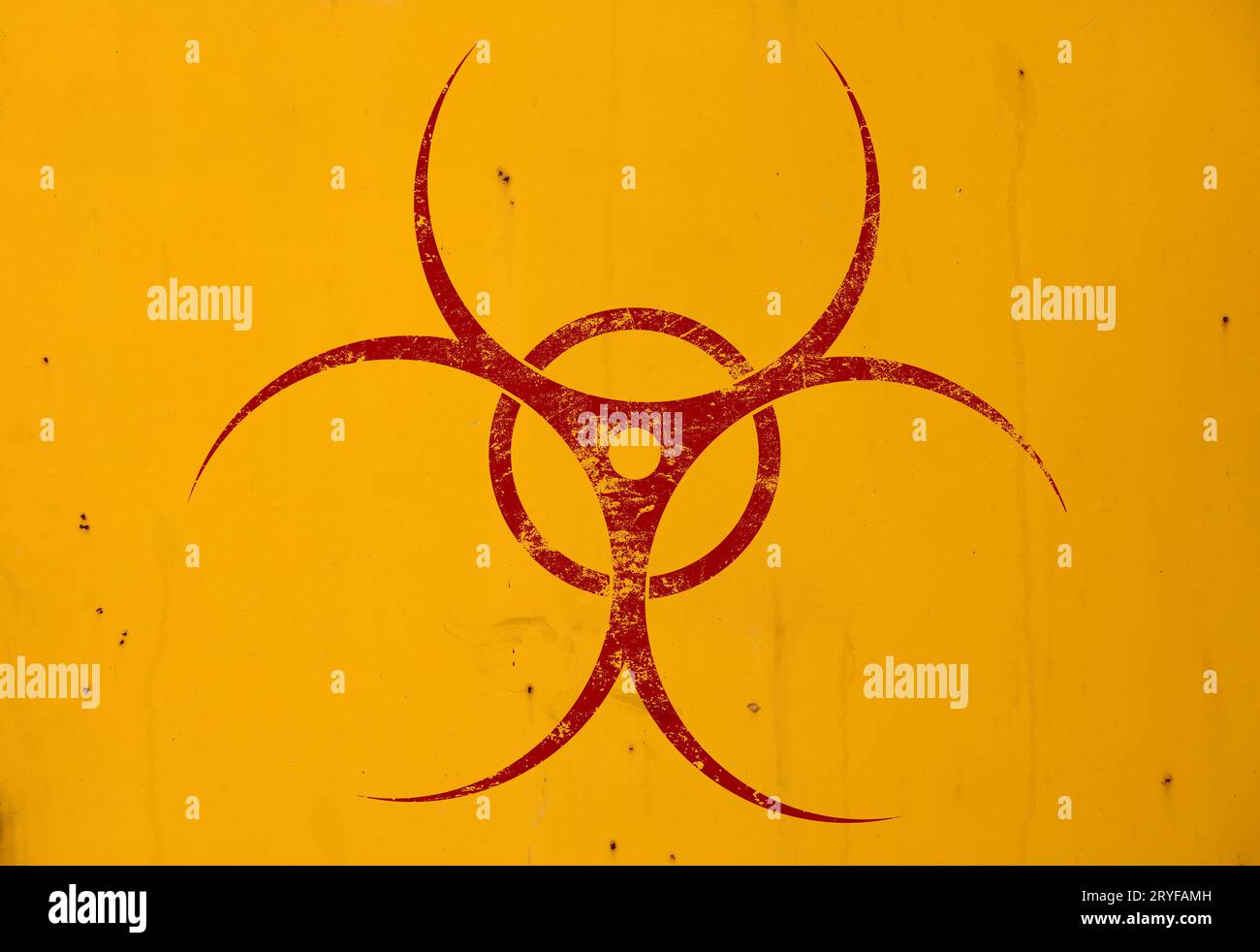 Red biohazard sign over yellow background Stock Photo - Alamy