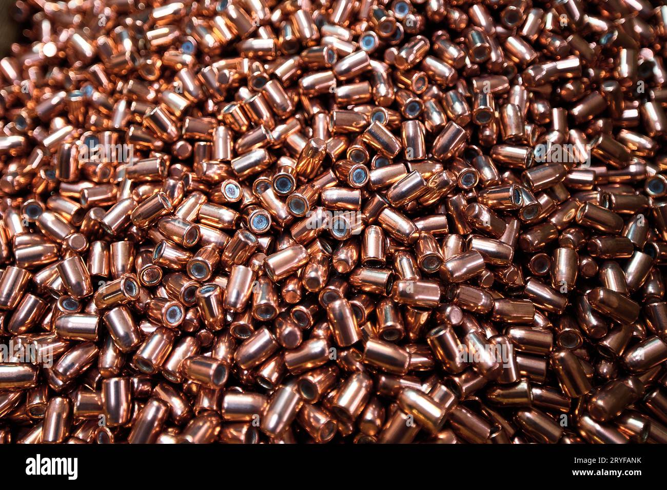 Brass metal bullets pile for weapons as background Stock Photo - Alamy