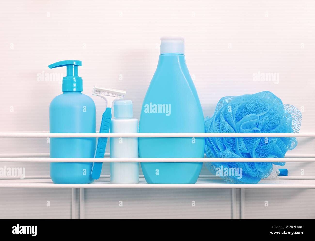 Blue bottles of hygiene toiletries in white bath Stock Photo - Alamy