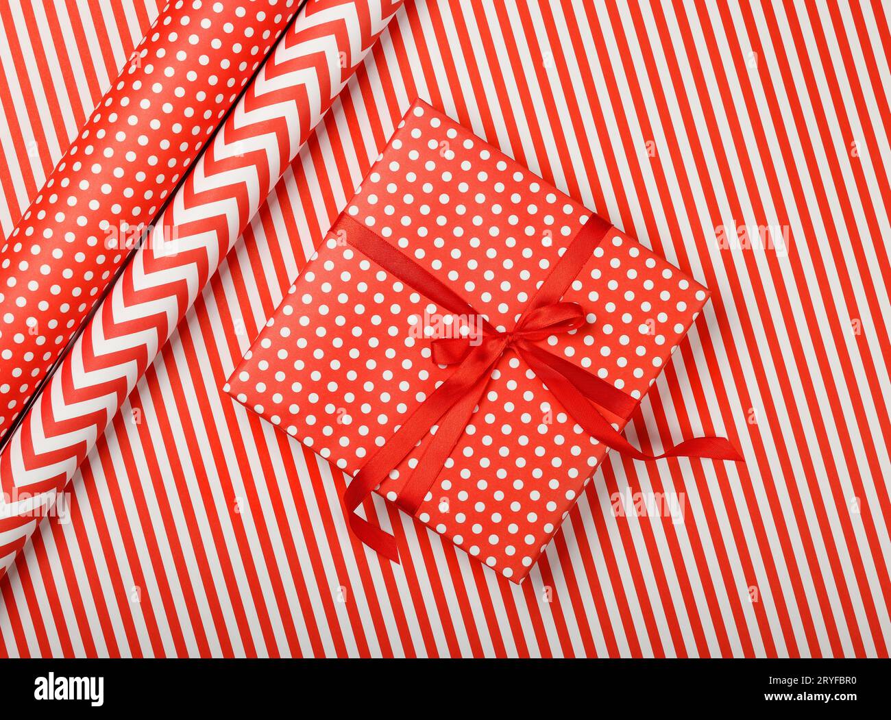 Packing gifts with red and white paper Stock Photo - Alamy