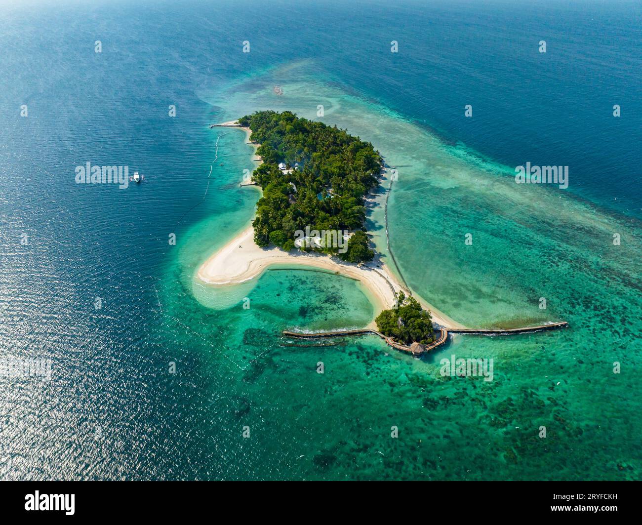 Blue ocean with sunlight reflection and white beach resort, view from ...