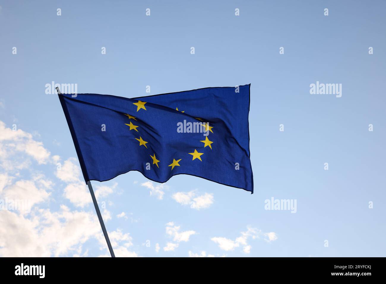 European Union EU flag waving in clear blue sky Stock Photo - Alamy