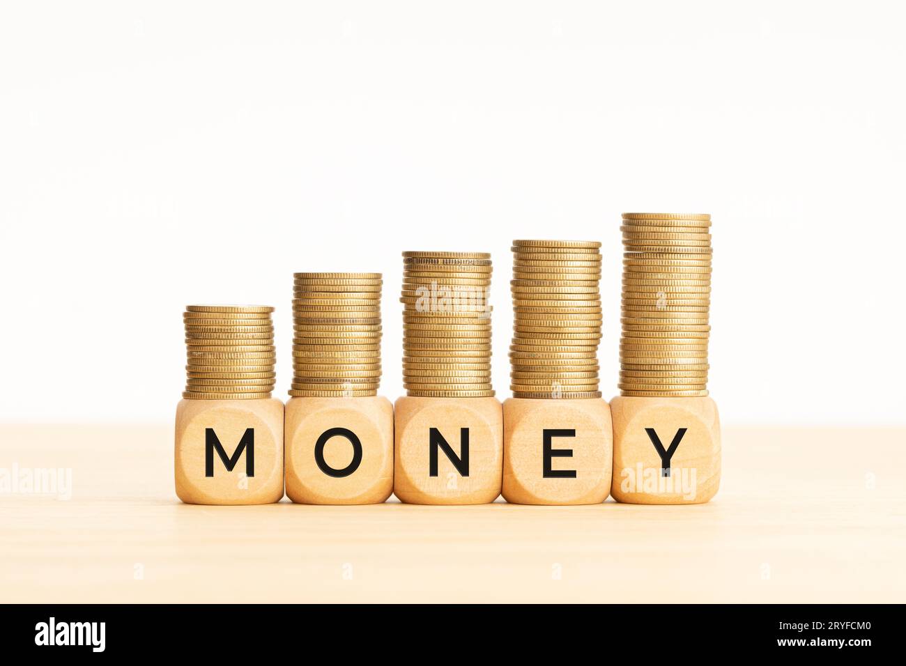 Wooden blocks coins money hi-res stock photography and images - Alamy