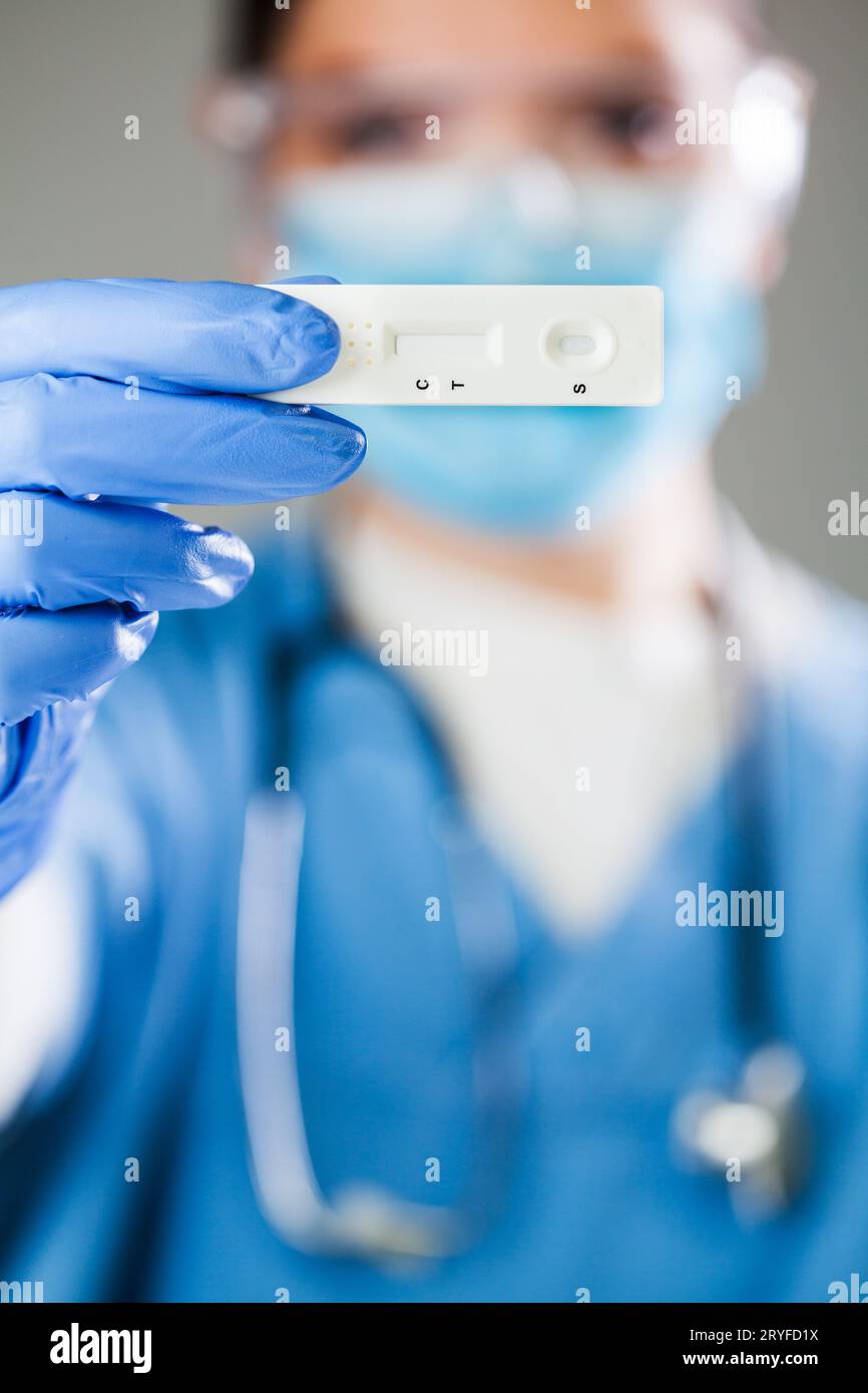 Female doctor holding Rapid Diagnostic Test serological test kit Stock ...