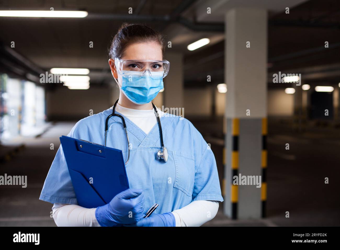 Portrait of young female emergency medical services worker on a parking ...