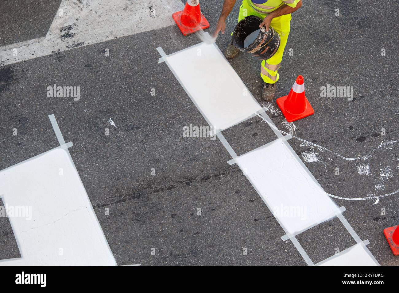 Road painter worker working on zebra crossing of a city street Stock ...
