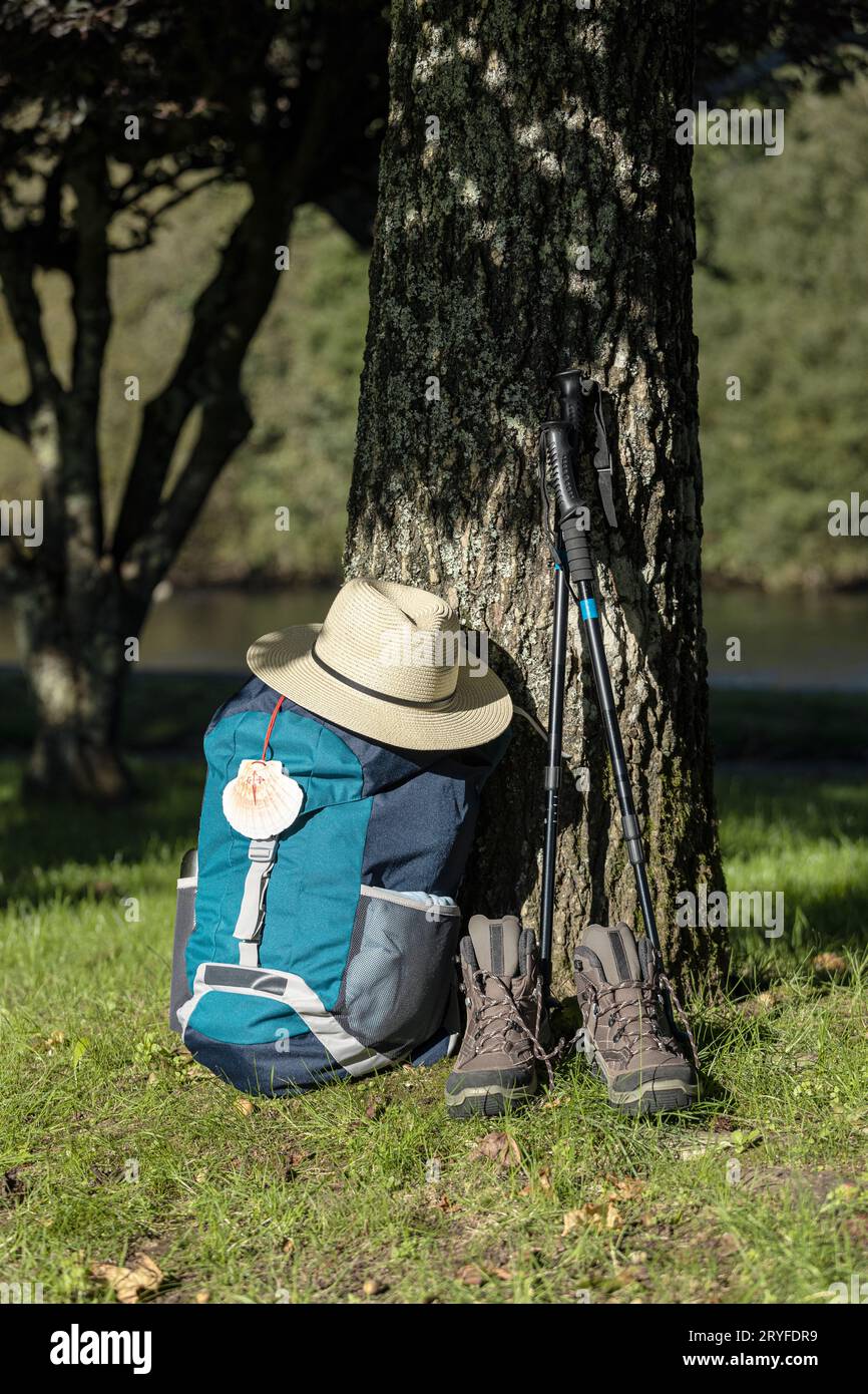 Backpack of a pilgrim leaning against a tree with a hat, trekking boots ...