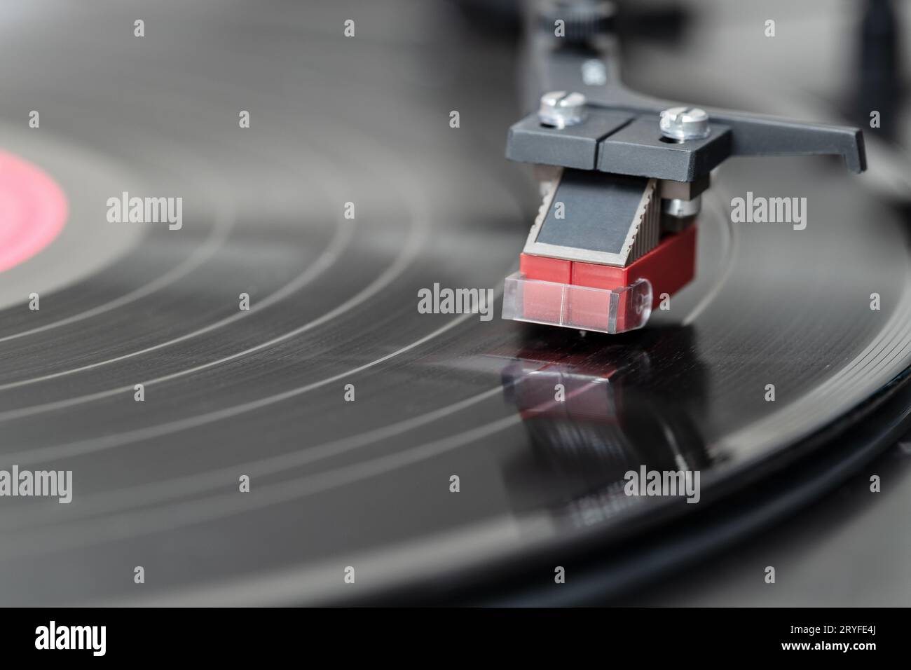 Closeup of vintage record player while playing a vinyl record. Black ...