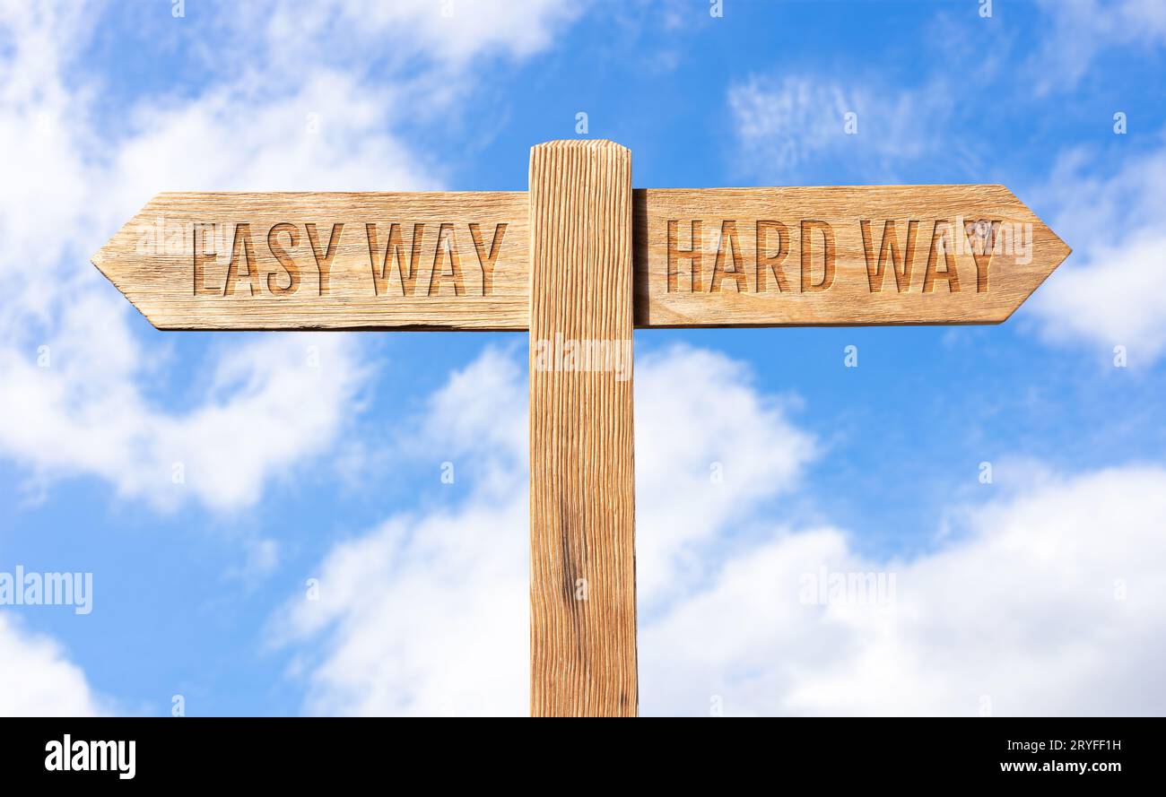 Easy way or hard way concept. Wooden signpost with message on sky ...
