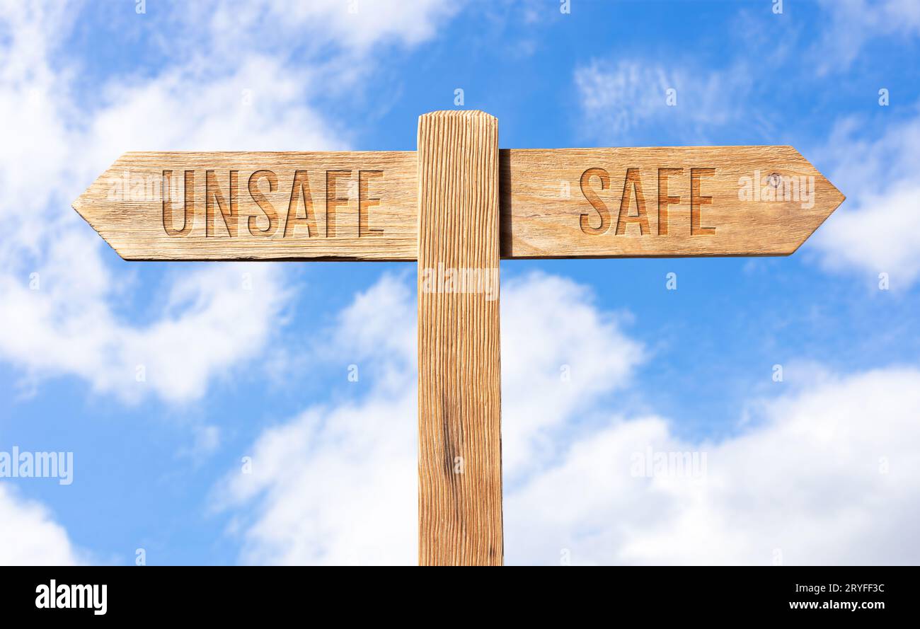 Unsafe or safe concept. Wooden signpost with message on sky background ...