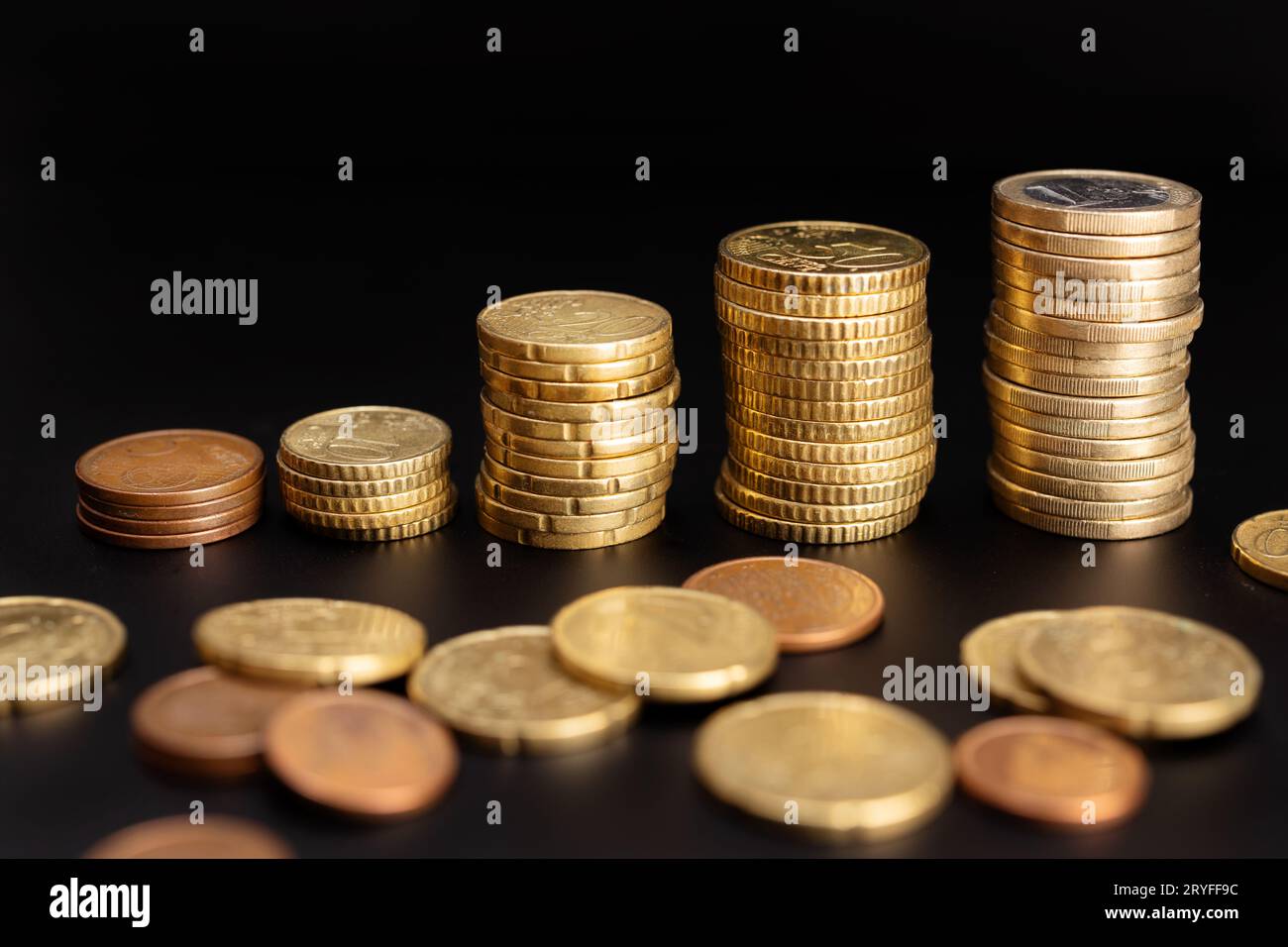 Rising euro Coin stacks on black background. Growth, income, savings ...
