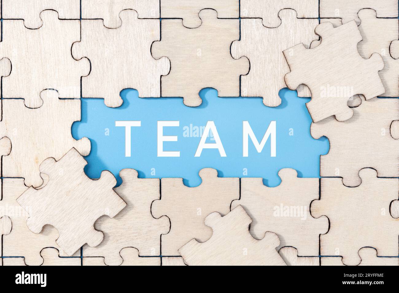 Team word on blue background surrounded by puzzle pieces Stock Photo ...
