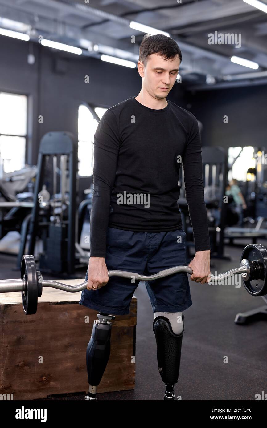 love of life. serious man is concentrated on lifting barbell. side view ...