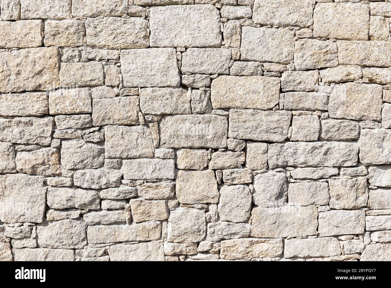 Granite Stone wall background texture. Dry masonry wall Stock Photo - Alamy