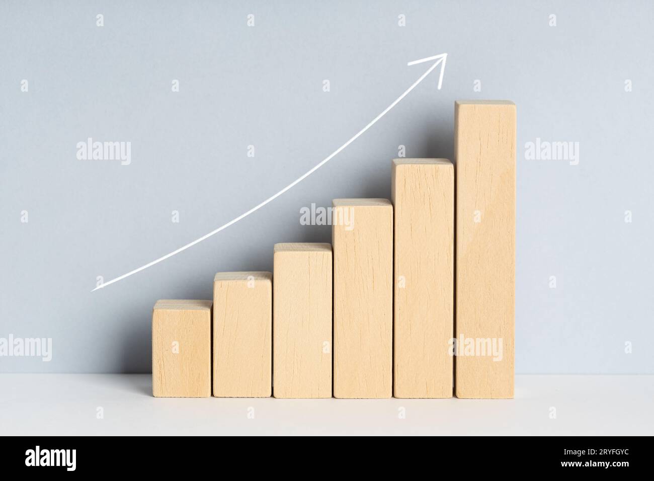 Wooden block financial bar chart graph with upward trend line drawn on ...
