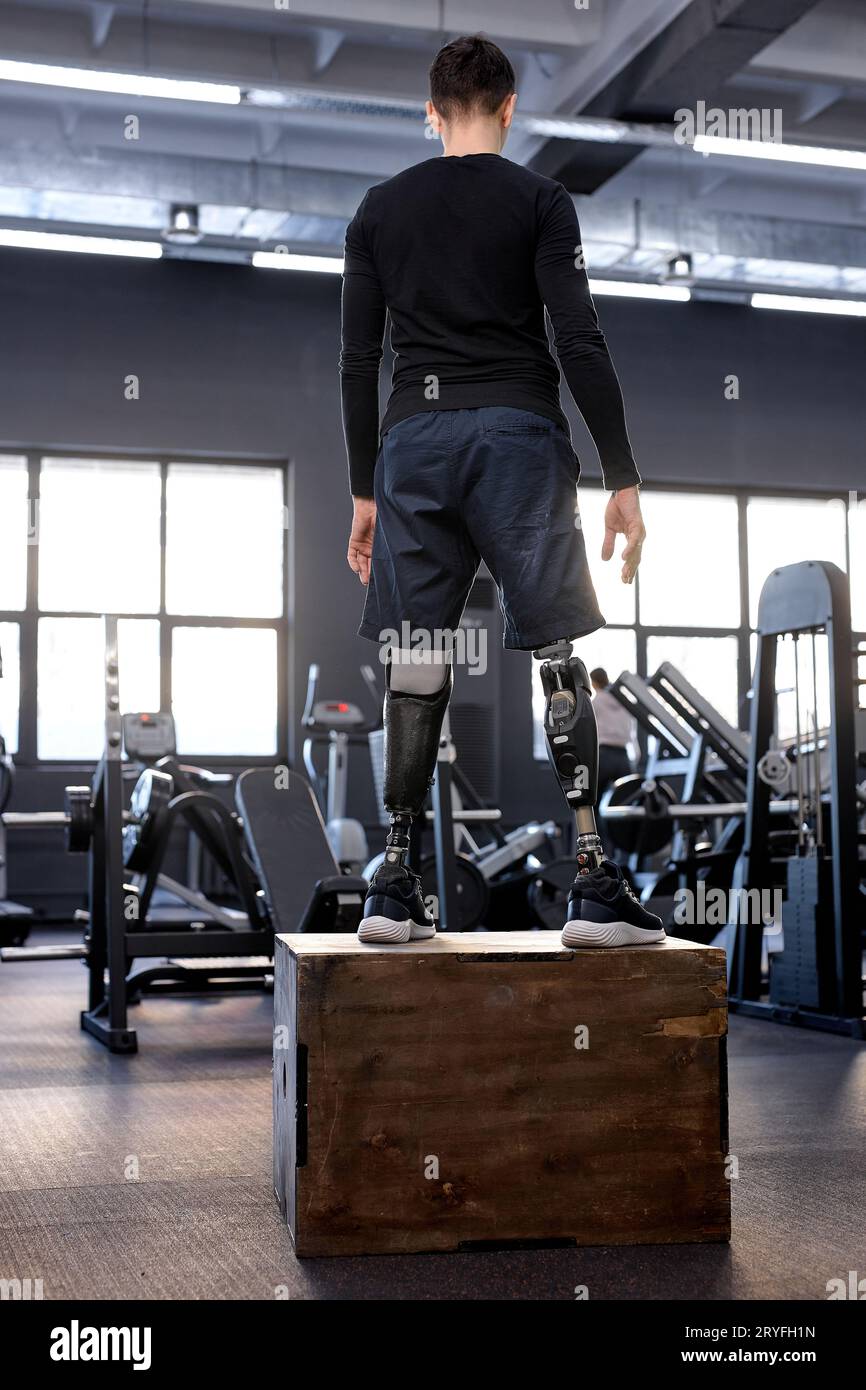 back view of disabled man resting on fit box. full length shot, being ...