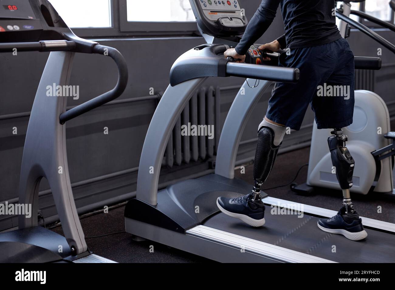 love of life. ambitious man without legs running at gym, the impossible ...