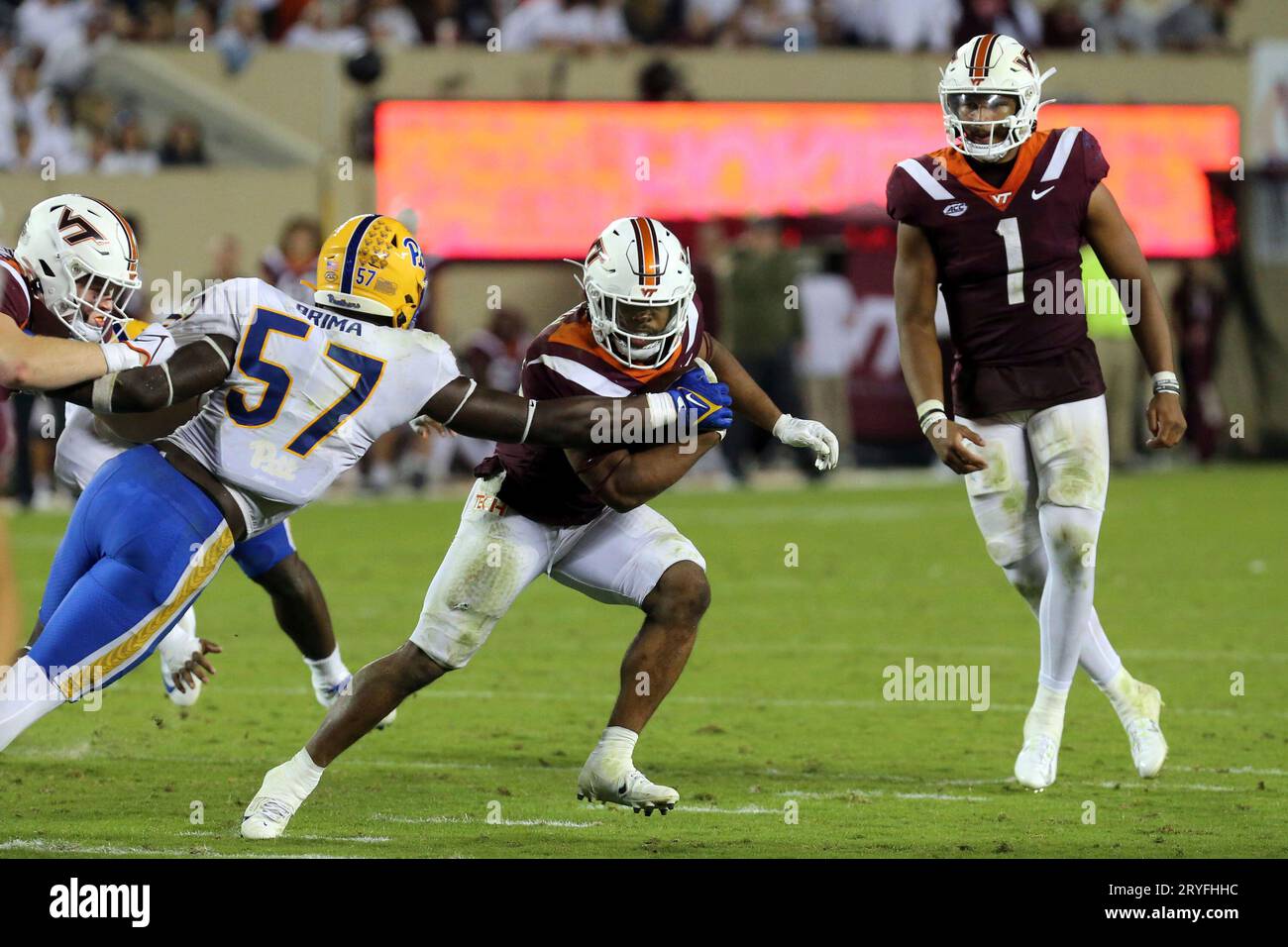 Pittsburgh defender Bam Brima (57) reaches for Virginia Tech running ...