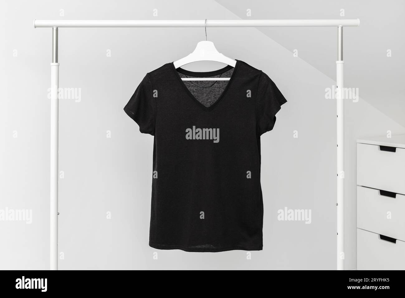 V neck t-shirt hanging on Clothing rack. Black color. Template, mock up ...