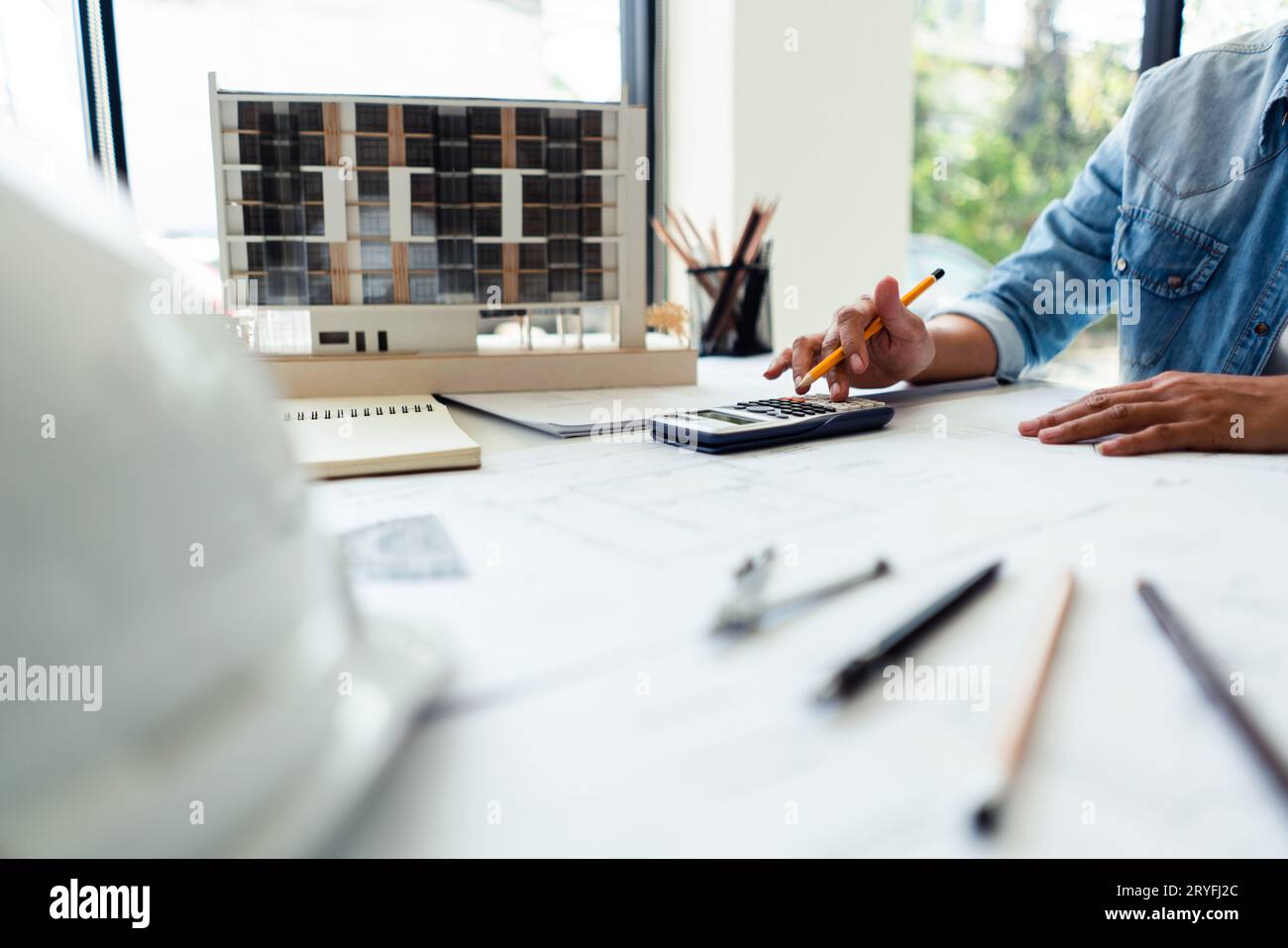 Engineer woman use scientific calculator and working to drawing ...