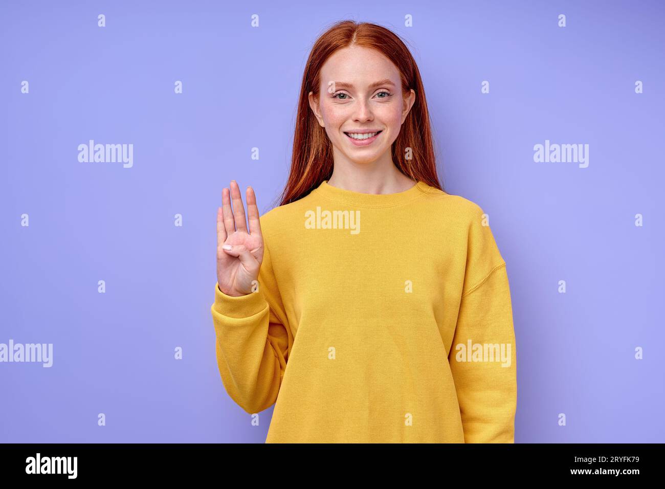 beautiful redhead happy cheerful girl, teacher showing number 4 on blue ...