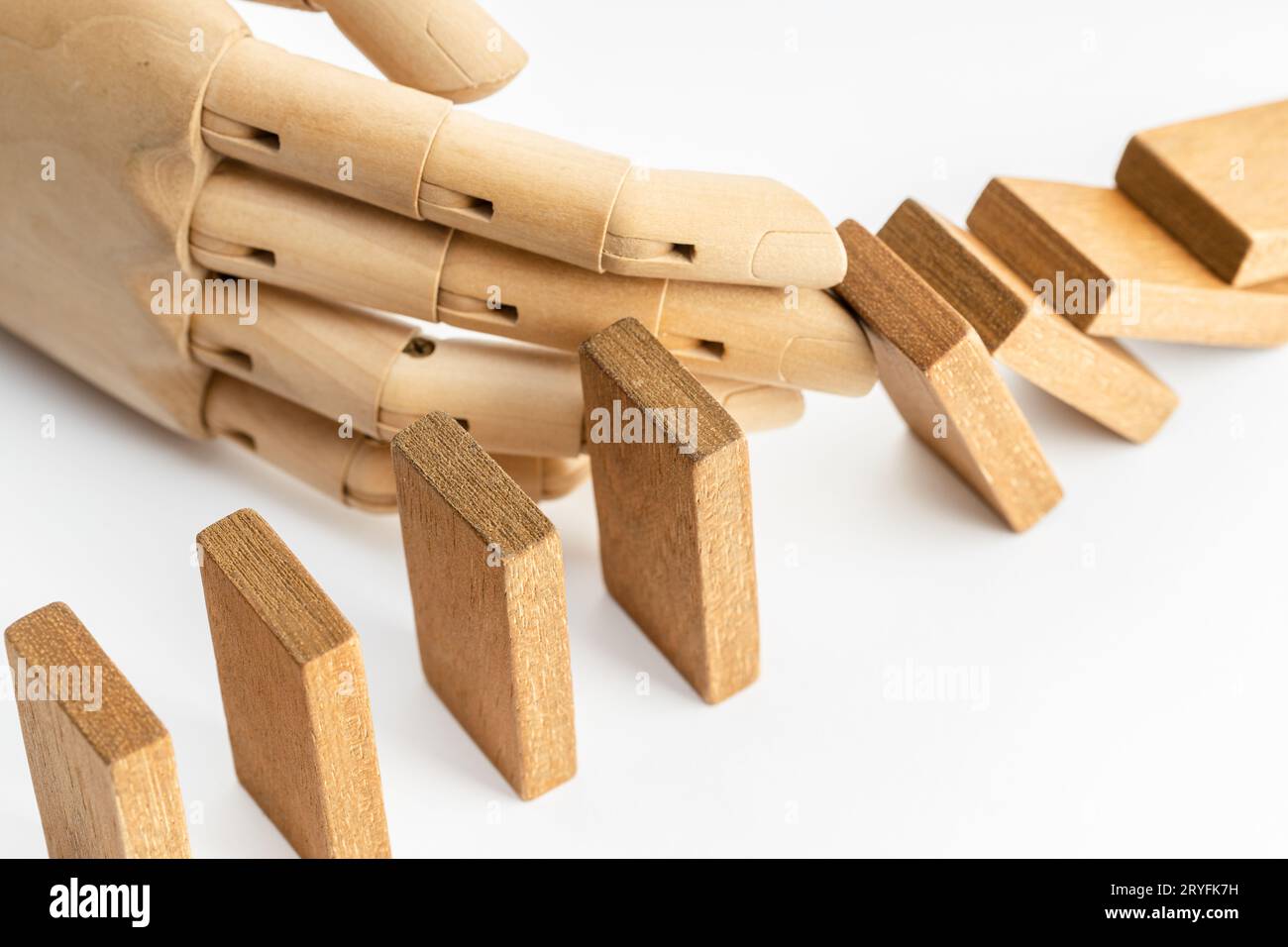 Wood hand Stopping Falling wooden Dominoes effect. Business Risk ...