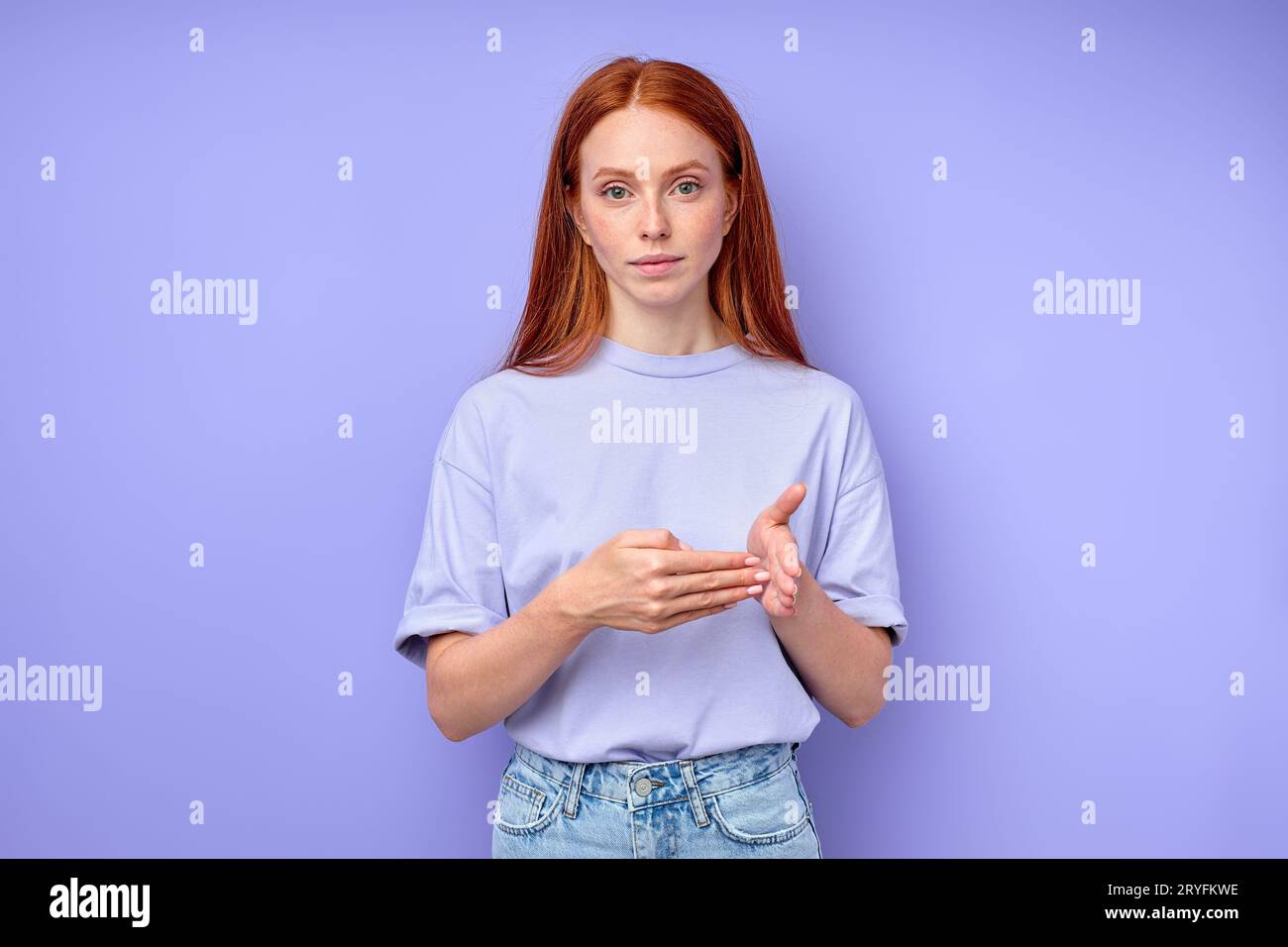 young red-haired good-looking girl working as a Sign language ...