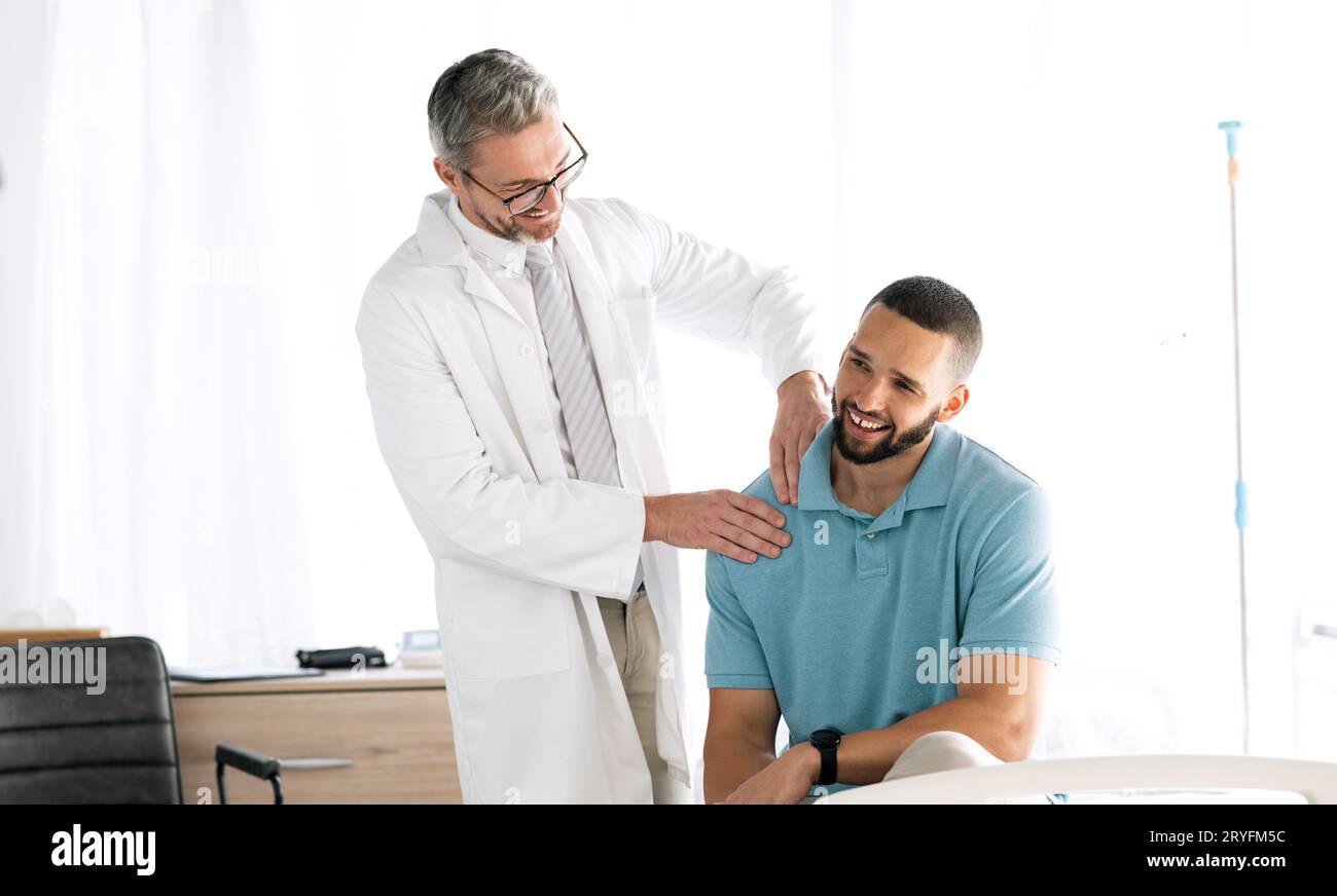 Doctor, men and consultation with conversation, healthcare and ...