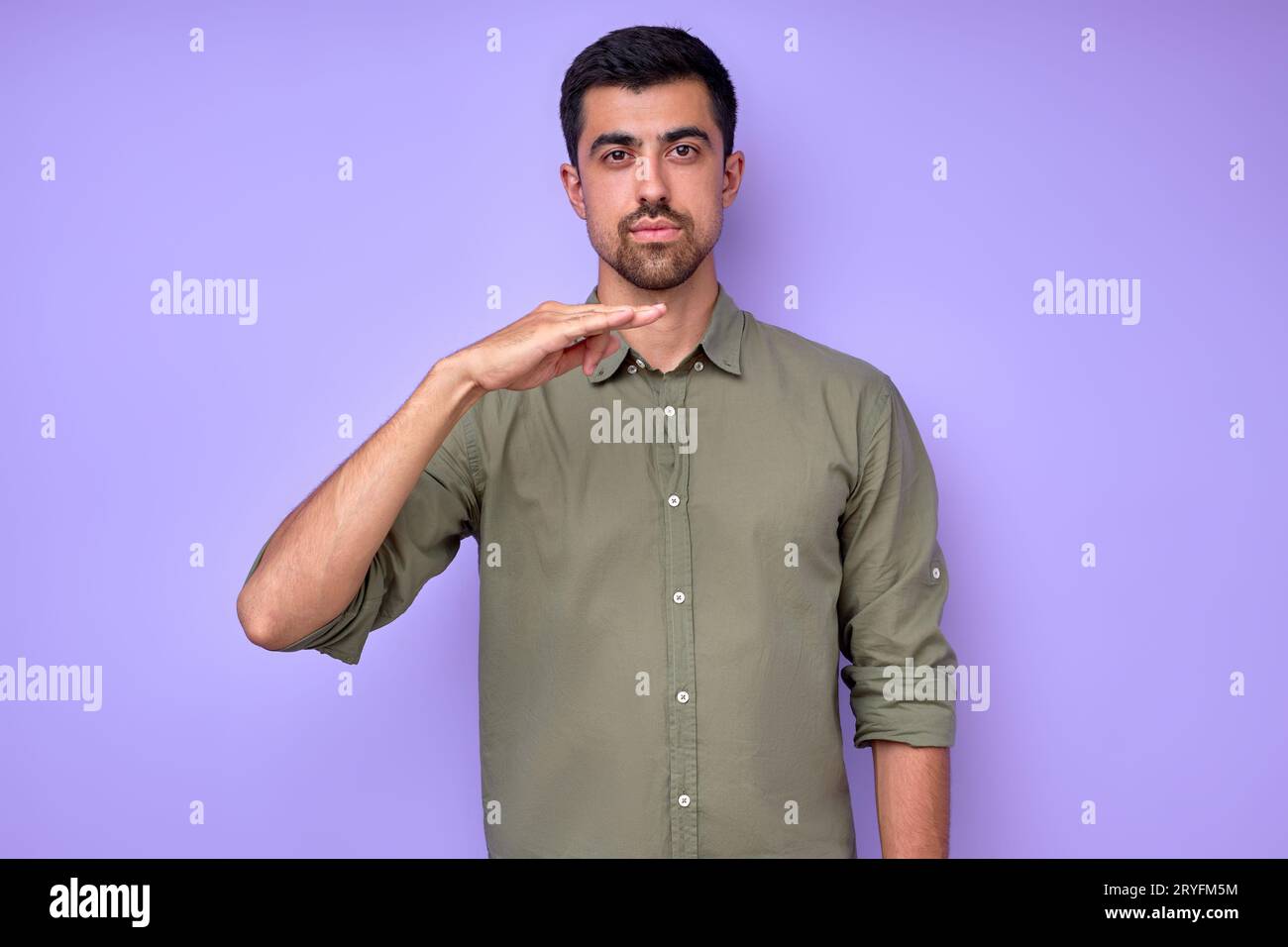 handsome man, teacher showing letter F on blue background. Sign ...