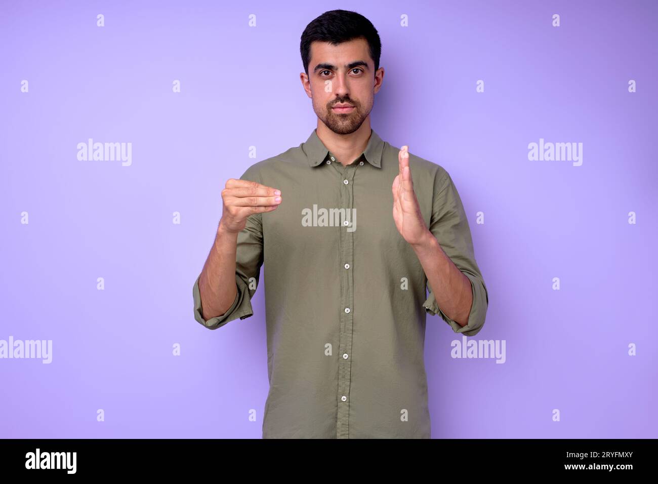 Young serious bearded deaf mute man showing number 500 using sign ...