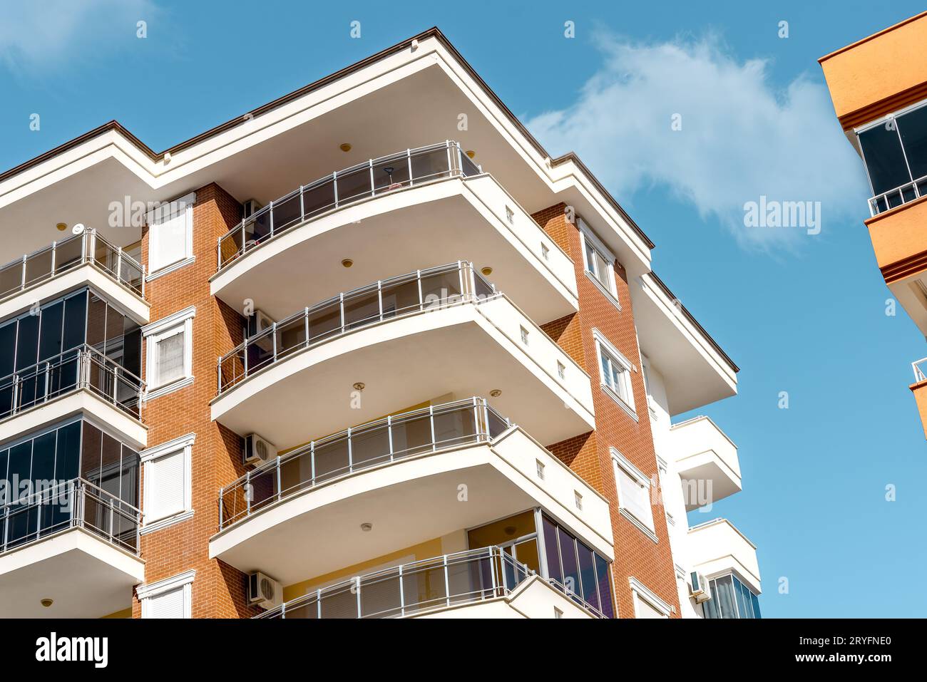 Balconies and blue sky with clouds. Part of a residential building in ...