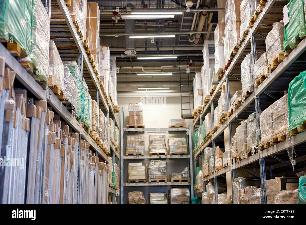 warehouse interior with shelves, pallets and boxes. Typical production ...