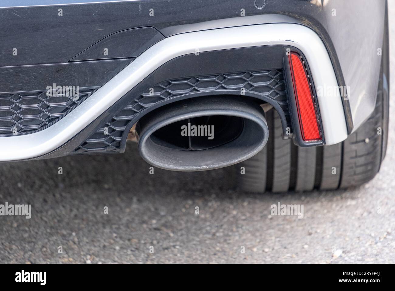 motor Vehicle Exhaust pipe with tires Stock Photo - Alamy