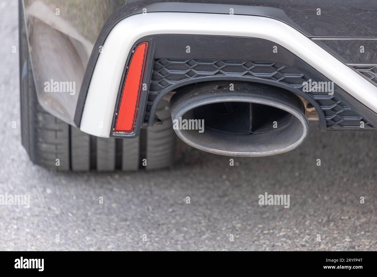 motor Vehicle Exhaust pipe with tires Stock Photo - Alamy